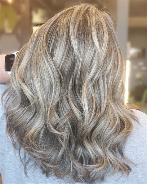 Cool Tone Blonde Transitioning To Gray Highlights And Low Lights For