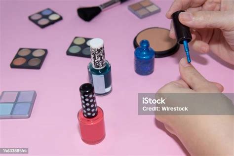 파란색 매니큐어로 손톱을 칠하는 여자의 손을 닫습니다 파스텔 핑크 백그로에 코스메틱 세트 갈색에 대한 스톡 사진 및 기타 이미지 갈색 개념 개념과 주제 Istock