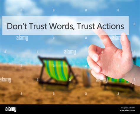 Don't Trust Words, Trust Actions - Hand pressing a button on blurred background concept ...