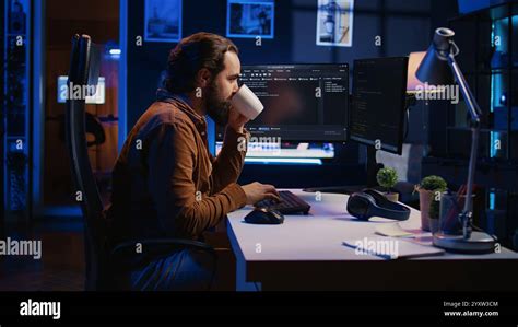 focused programmer drinking coffee in apartment while solving database errors on computer