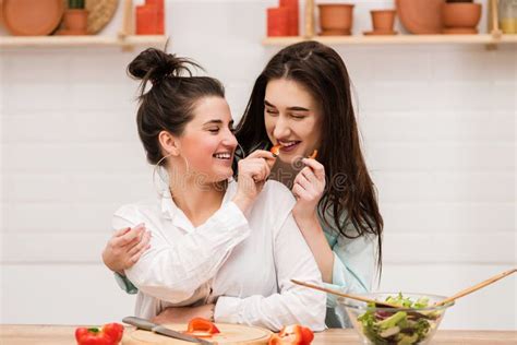Two Brunettes Feed Each Other With Pepper Slices Stock Image Image Of