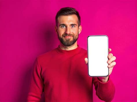 A Man Is Holding A Mobile Phone And Showing A Blank White Screen