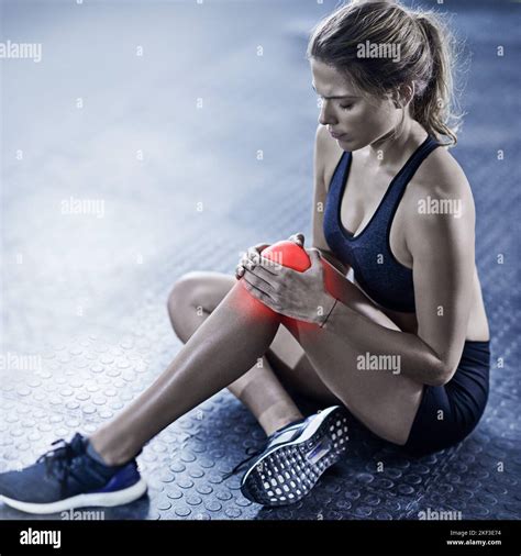 Let Pain Be Your Motivation A Young Woman Holding Her Injured Knee
