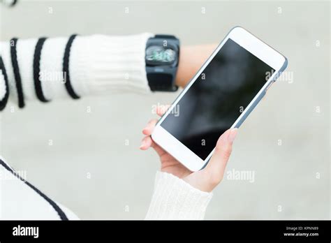 Woman Connecting Smart Watch With Cellphone Stock Photo Alamy