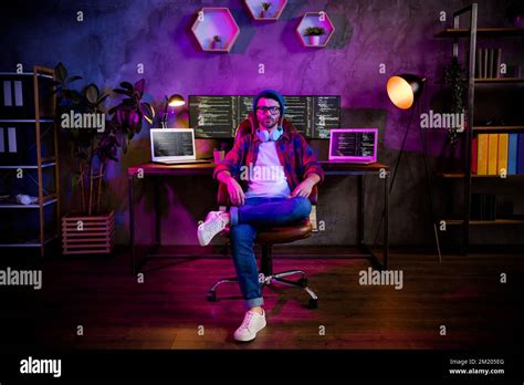 Photo Of Cool Serious Coder Dressed Hat Eyewear Working Alone Late Evening Shift Indoors