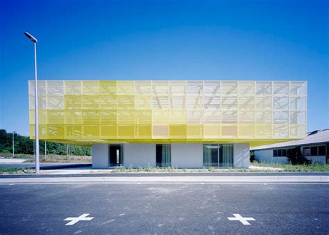 Yellow Mesh Box Sits Atop Ateliers O S S School Building