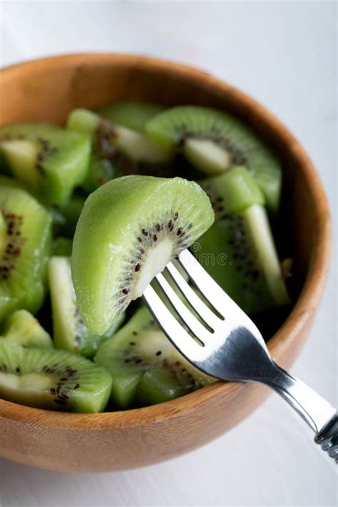 Kiwi And Kiwi Fruit Salad In Wooden Bowl Selective Focus Stock Image