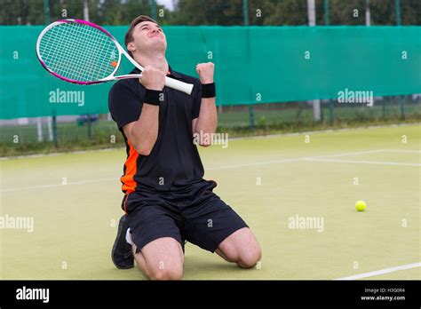 Young Male Player Fell On His Knees And Made A Fist Because Of The Win In A Match At The Tennis