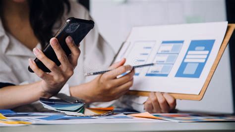 Close Up Ux Developer And Ui Designer Brainstorming About Mobile App Interface Wireframe Design