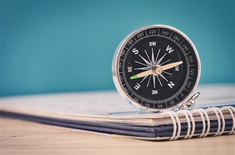 Premium Photo Close Up Of Compass And Book On Table
