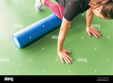Attractive Female Doing Foam Roller Exercise And Posing In Modern
