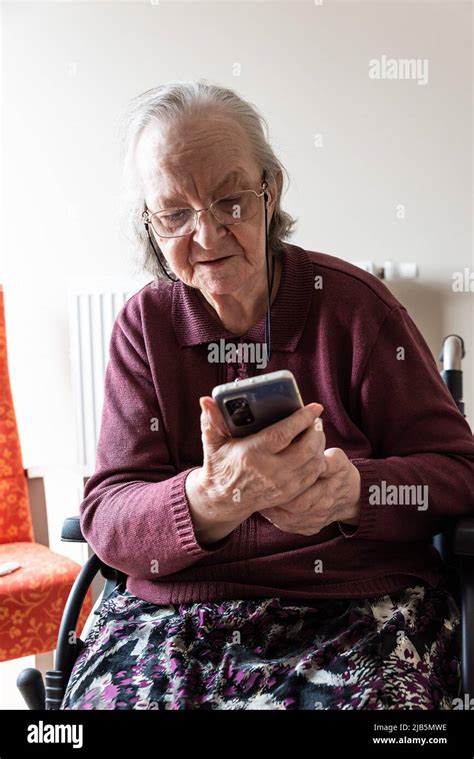 83 Year Old Grandmother Having A Video Call Sitting In A Wheelchair