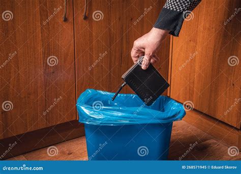 A Man Throws A WiFi Router In The Trash Man S Hand With A WiFi Router And A Trash Can In Blue