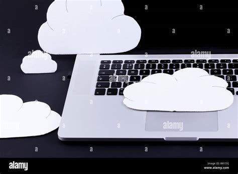 Cloud Computing Concept With Cutout Clouds Above A Laptop Computer