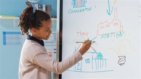 Elementary School Science Class Portrait Of Cute Girl Uses Interactive Digital Whiteboard To