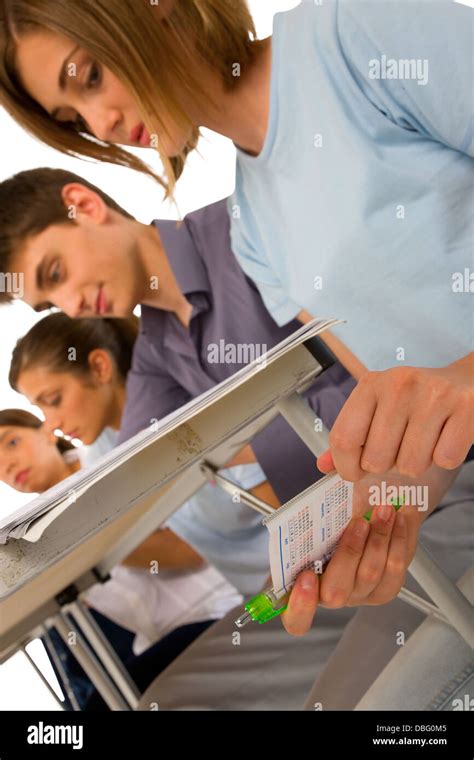 Teenage Girl Copying Classmate S Assignment Stock Photo Alamy