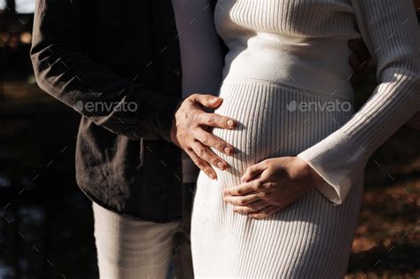 Family day. Stylish unrecognisable marriage pregnant couple waiting for ...