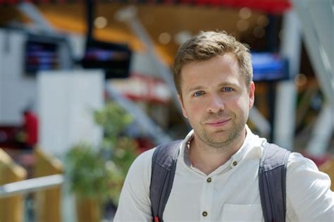Premium Photo Portrait Of Smiling Caucasian Man On Blurred City