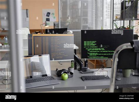 Background Shot Of Programmer Desk Setup With Laptop And Computer