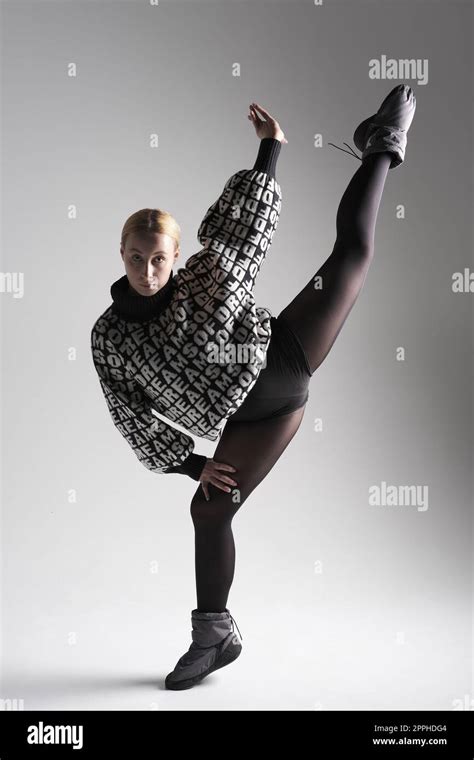 Ballet Dancer Woman Black Dress On Gray Background Ballerina Posing And Showing Her Flexibility