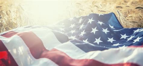 Premium Photo American Flag Lies On The Golden Wheat Field