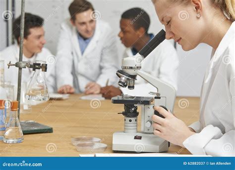 Female Pupil Using Microscope In Science Lesson Stock Image Image Of