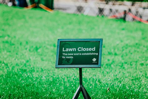 Green And Black Wooden Signage On Green Grass Field During Daytime Photo Free Green Image On