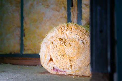 Glass Wool In A Roll On The Floor While Filling The Cavities Between