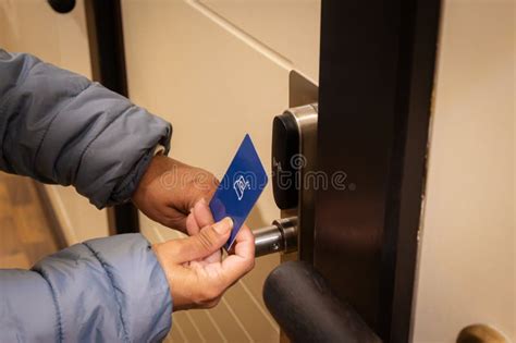 Woman Hand Using Electronic Smart Key Card To Unlock Door In Hotel Or