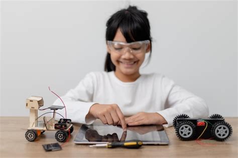 Premium Photo Asia Students Learn At Home In Coding Robot Cars And