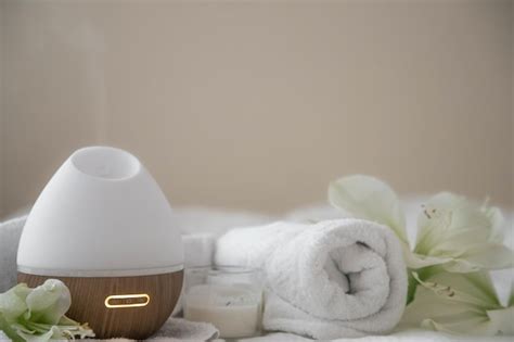 Free Photo Cozy Spa Composition With Aroma Diffuser Candle And Flowers