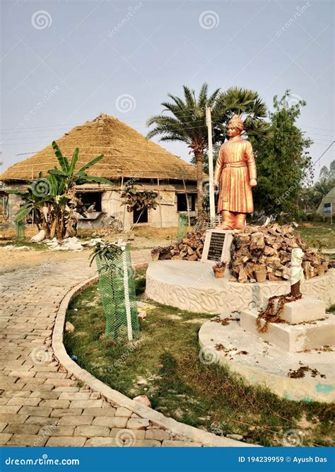 A Small Statue Of Swami Vivekananda With A Village Hut Next To It At A