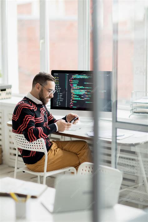Premium Photo Smiling Programmer Working In Office