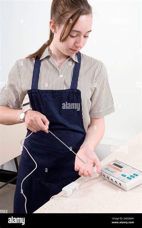 Temperature Probe And Data Logger Babe Holding An Electronic Temperature Probe Connected To