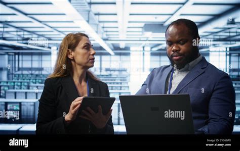 Teamworking Technicians Managing Data Center With Advanced Technology
