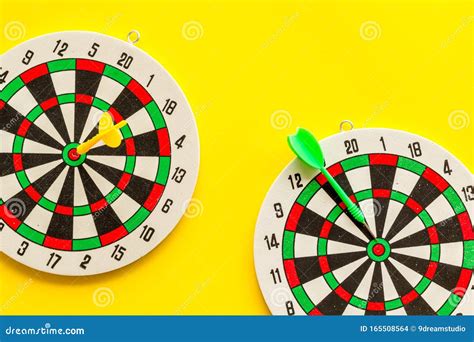 Accuracy Of Precision Concept Dartboard And Arrows On Yellow