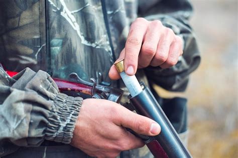 Premium Photo Close Up Of Hunter Loading Shotgun Premium Photo Close Up Of Hunter Loading Shotgun