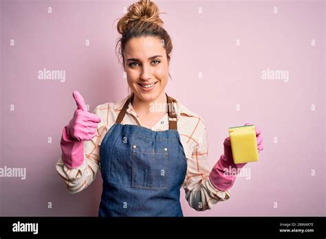 Beautiful Blonde Cleaner Woman Doing Housework Wearing Arpon And Gloves