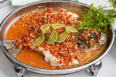 A Spicy Sea Bass With Chopped Peppers In Thai Sauce Stock Image Image