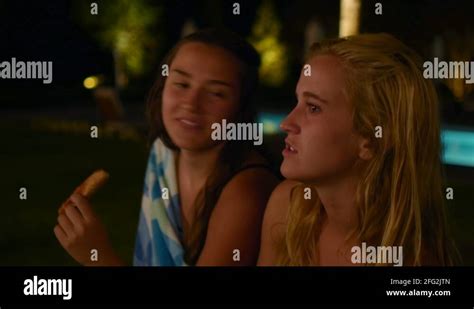 Two Teen Girls Joking Around At Pool Party Girl Takes A Bite Of Friend