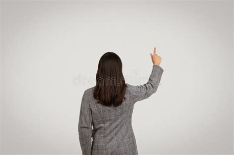 Back View Of Businesswoman Pointing On Virtual Screen Touching