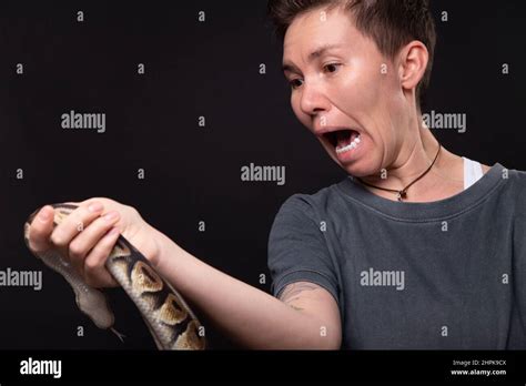 Photo Of Scared Woman With Python On Black Background Stock Photo Alamy