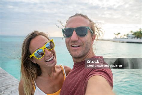 나무 부두에 쾌활한 젊은 부부는 열대 암초 바다 위의 셀카 초상화를 가지고 커플 데 재미 웃음 에 휴가 20 29세에 대한 스톡 사진 및 기타 이미지 Istock