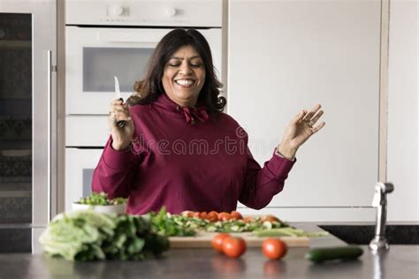 Cheerful Carefree Mature Indian Housewife Woman Preparing Homemade Dinner Stock Image Image Of