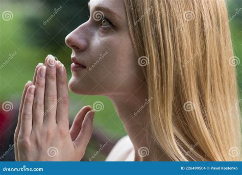 Portrait Of A Spiritual Young And Attractive Blonde Girl Lady Pray To