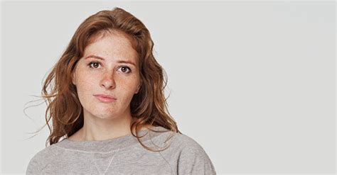 Portrait Of A Pretty Young Serious Redhead Woman Posing Isolated Over White Wall Background