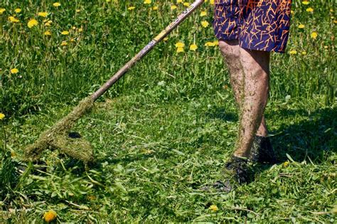 Man Uses String Trimmer Without Protective Clothing His Bare Legs
