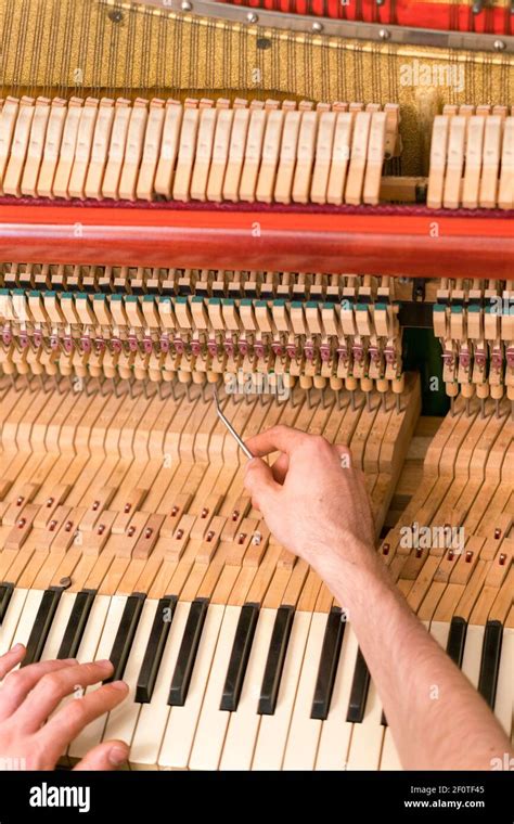 Piano Tuning Process Closeup Of Hand And Tools Of Tuner Working On