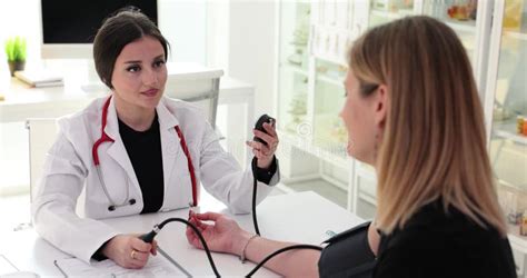 Female Doctor Measures Blood Pressure Of Patient In Clinic Stock Video