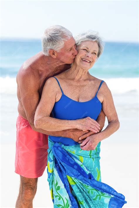 Premium Photo Cute Mature Couple Embracing On The Beach